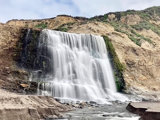 Water transforms into a silky curtain as it meets ancient rock. Photographers call this "the money shot" – and no filter is needed.