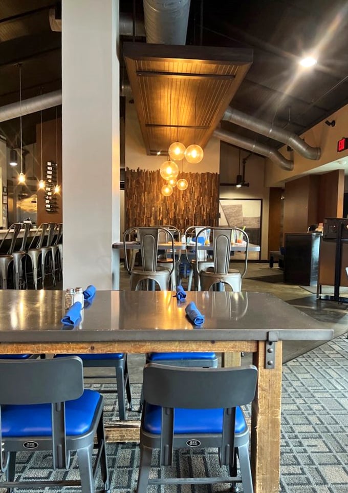 Modern industrial elements meet warm wood tones in a dining space that feels both contemporary and timeless – like the menu itself.