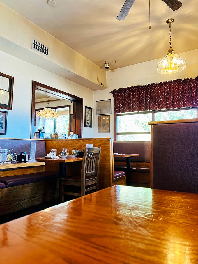 Warm wood tones, burgundy accents, and those distinctive hanging lights create the perfect backdrop for making breakfast memories that last.