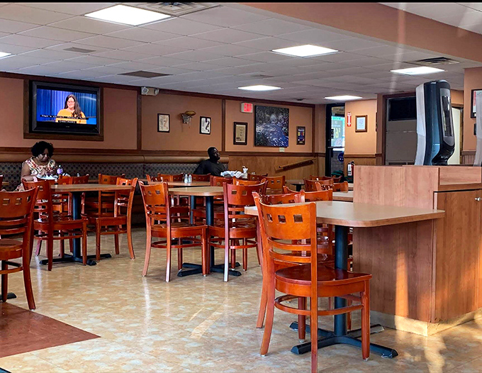 The dining area balances comfort with efficiency, where ceiling fans gently circulate the intoxicating aromas of grilled perfection throughout the room.
