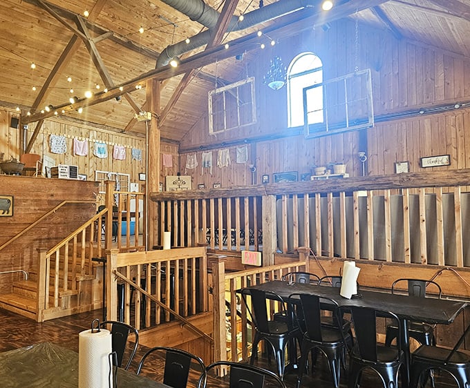 The dining area radiates rustic charm with wooden railings and natural light. Like eating in a Pinterest board that actually delivers on its promises.