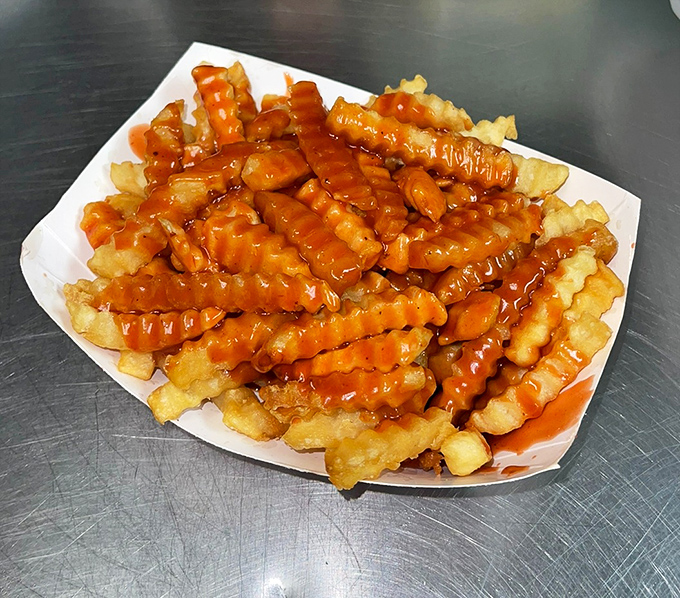 Crinkle-cut fries swimming in BBQ sauce – proving that even side dishes deserve their moment in the spotlight.