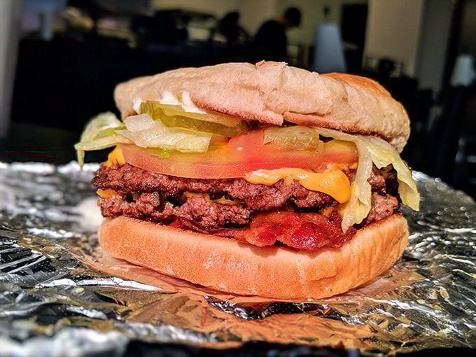 This isn't just a bacon cheeseburger – it's a monument to the perfect ratio of meat, cheese, bacon, and fresh toppings.