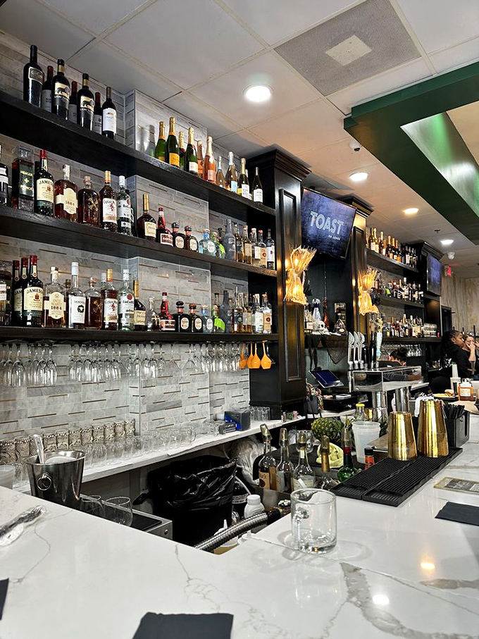 The bar at Toast on Lenox isn't just stocked—it's curated, with bottles lined up like soldiers ready to enhance your brunch battle plan.