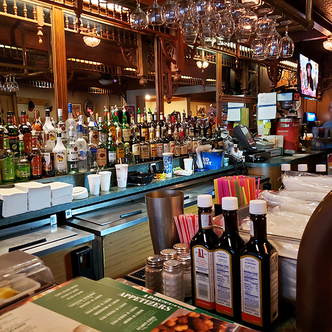 The bar isn't trying to be trendy—it's aiming for timeless. Where glasses hang like crystal stalactites, promising libations to complement those legendary steaks.