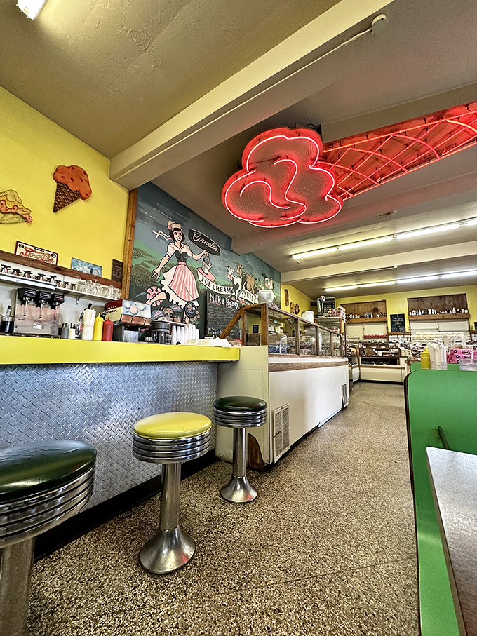 Chrome stools and yellow counters create the perfect perch for milkshake contemplation. This isn't decoration—it's time travel.