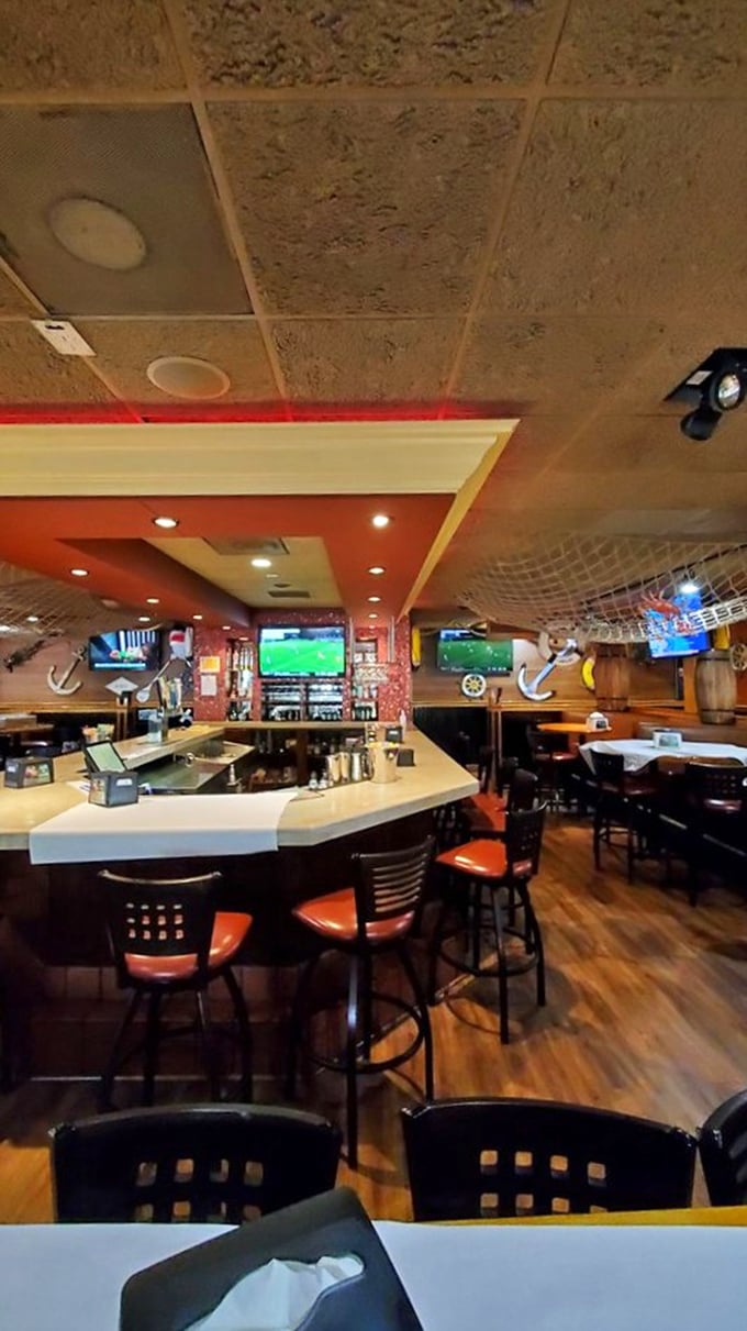The bar area—where fishing stories get taller and seafood appreciation grows deeper with each round of drinks.