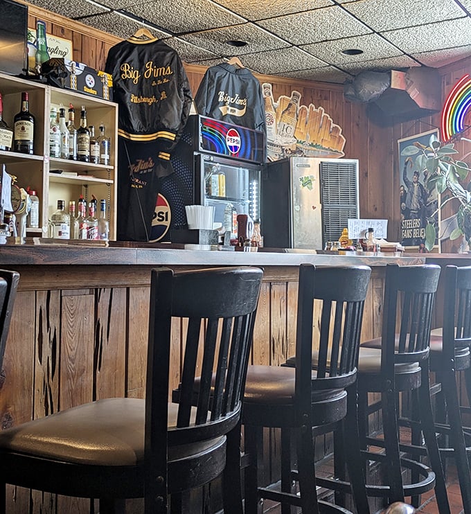 Bar stools that have supported generations of Pittsburghers, with Big Jim's merchandise proudly displayed – souvenirs for those who survived their portion sizes.