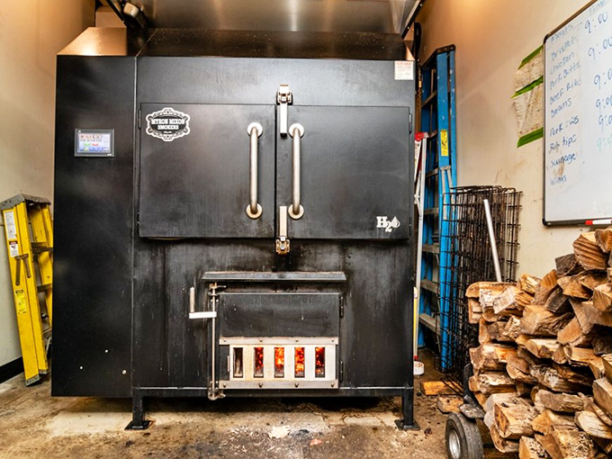 The beast behind the feast – this imposing smoker transforms humble cuts into heavenly barbecue through patience, expertise, and a whole lot of hardwood.