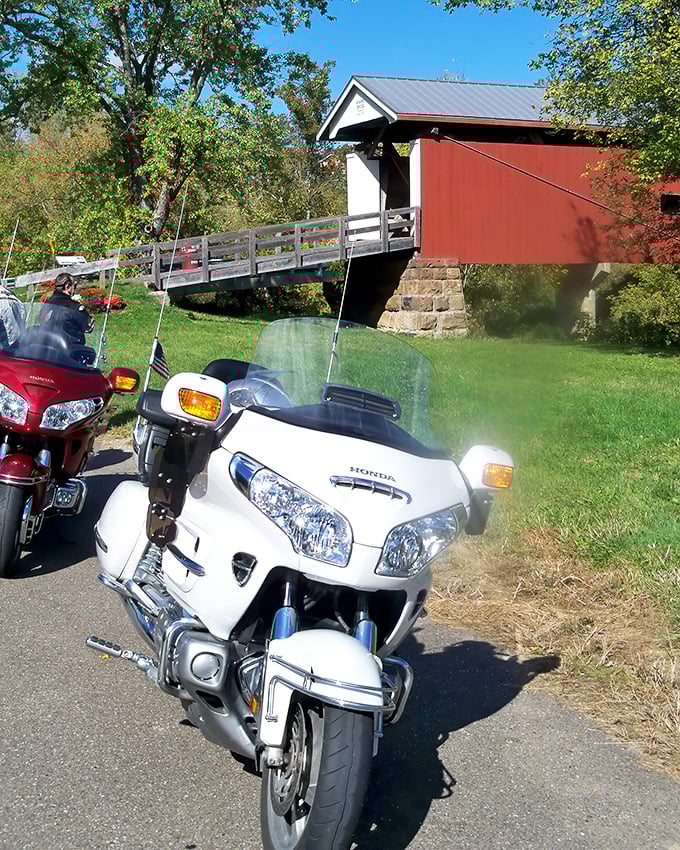 Motorcycle enthusiasts know the best roads lead to hidden treasures—this covered bridge makes a perfect pit stop on a sunny afternoon ride.