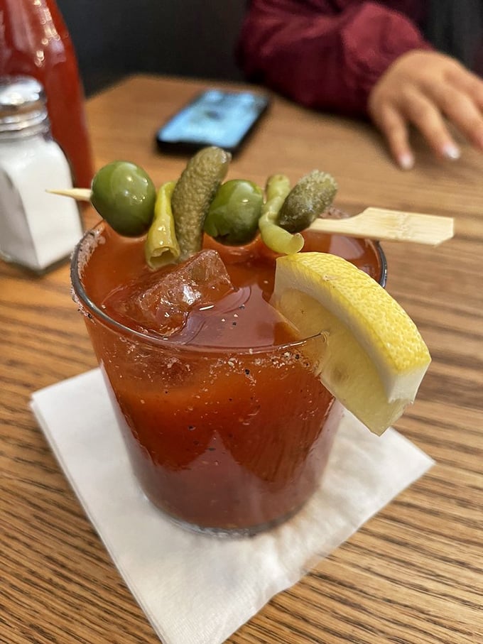 A Bloody Mary garnished like a pickle parade float – because sometimes breakfast needs a little liquid courage and vegetable therapy.