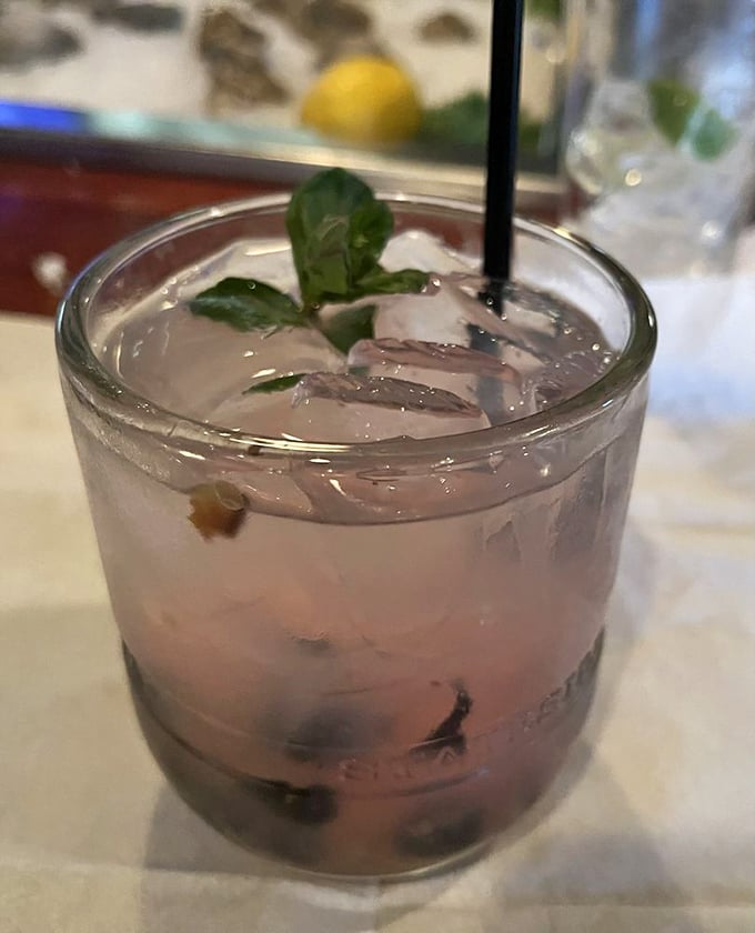 This blueberry lemonade smash cocktail brings summer vibes to any season with its refreshing, fruity appeal.