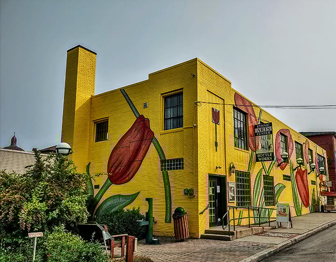 The Bottle Works building bursts with color like a flower blooming through concrete – art finding its way despite industrial roots.
