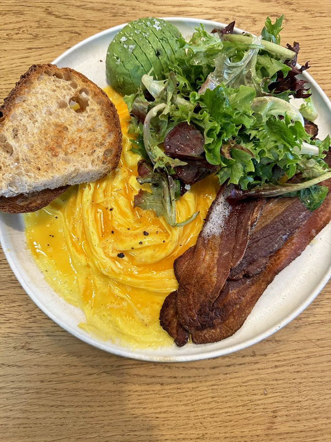 Breakfast that doesn't just break the fast – it demolishes it with perfectly cooked eggs, crispy bacon, and greens that make you feel virtuous.