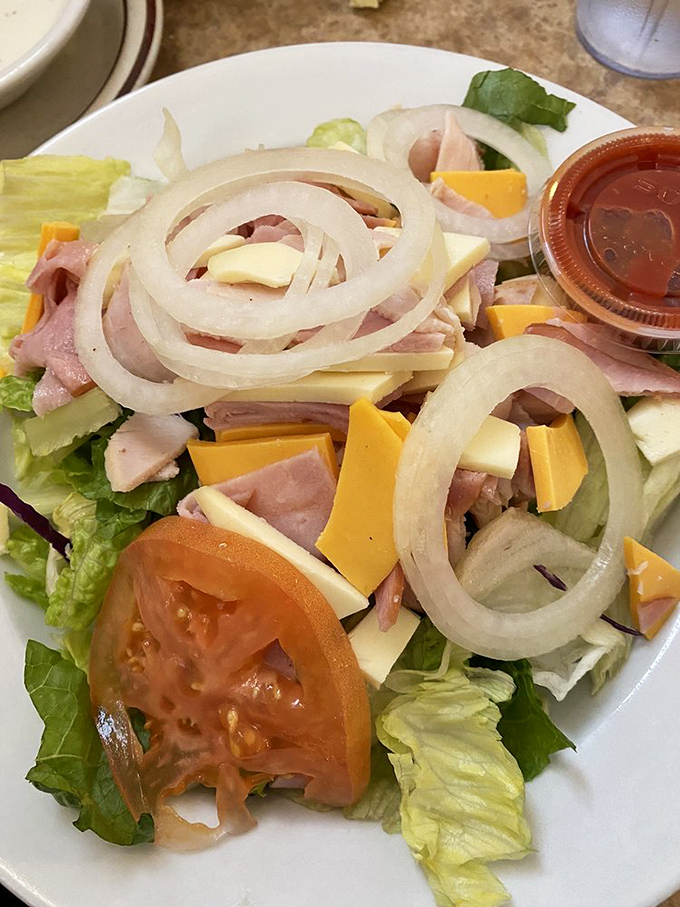 A chef salad that doesn't apologize for being exactly what it is: cold cuts, cheese, and vegetables arranged with straightforward honesty.