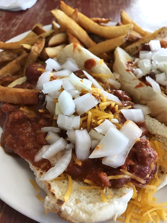 Chili cheese dog architecture that defies gravity and good sense—a beautiful mess that requires strategy, napkins, and absolutely zero regrets.