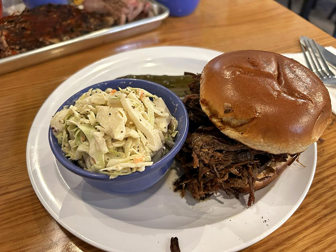 The pulled pork sandwich—where slow-smoked porcine perfection meets pillowy bun in a relationship your taste buds will want to third-wheel.