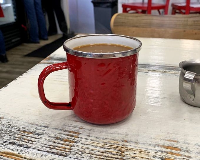 Coffee served in a red enamel mug—simple, unpretentious, and exactly right. The kind of cup that makes Monday mornings slightly more bearable.