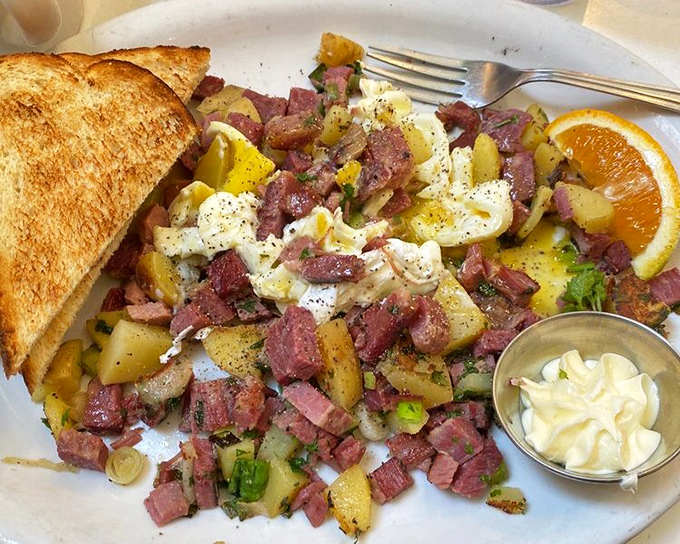 Corned beef hash that doesn't hide from the camera—it poses proudly with its eggy companions and toasty sidekicks, ready for its breakfast close-up.