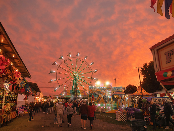 The county fair transforms dusk into magic, when ferris wheel lights compete with sunset colors in a show that no smartphone camera can truly capture.