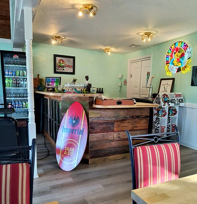 The bar area combines beach-town casual with rustic charm. That surfboard isn't just decoration—it's a reminder you're dining in a slice of Florida paradise.