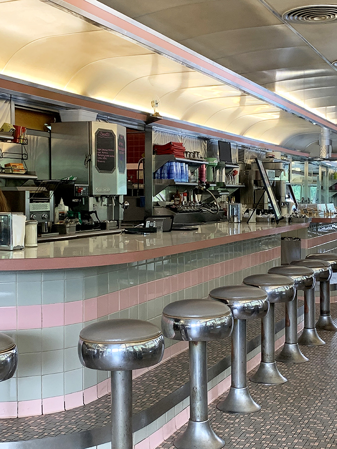 The counter's pink and white tile work isn't retro by design—it's authentic by survival, a testament to enduring quality over passing trends.