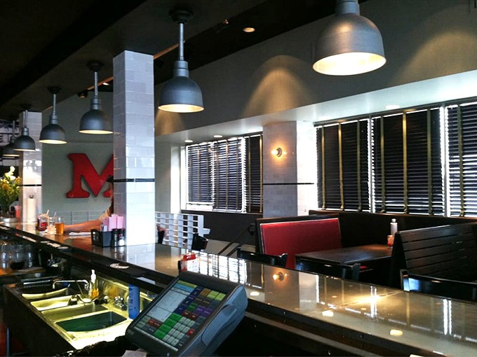 Clean lines, industrial lighting, and that bold red "M"—Mercury's counter area blends modern efficiency with classic burger joint charm.