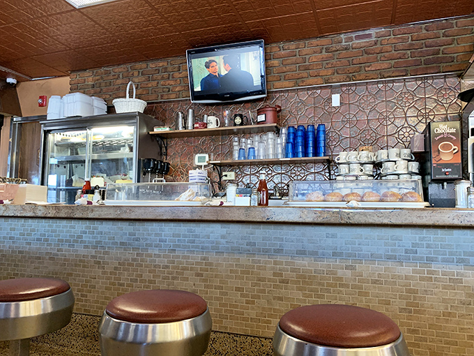 The counter – where breakfast dreams are born and coffee cups never reach empty, a front-row seat to the diner's choreographed morning ballet.