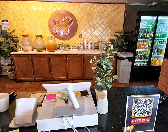 The drink station offers liquid refreshment with the same golden pig logo—a reminder that even the beverages here are part of the experience.