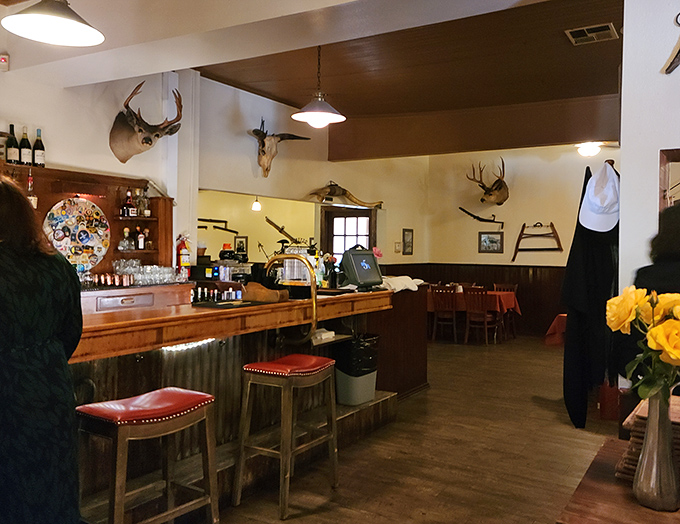 The bar's rustic charm—complete with mounted trophies—reminds you this is a place that takes its meat seriously.