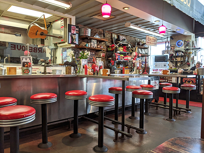 Red vinyl stools lined up like eager diners, ready for the barbecue show. The counter service experience is theater in its most delicious form.