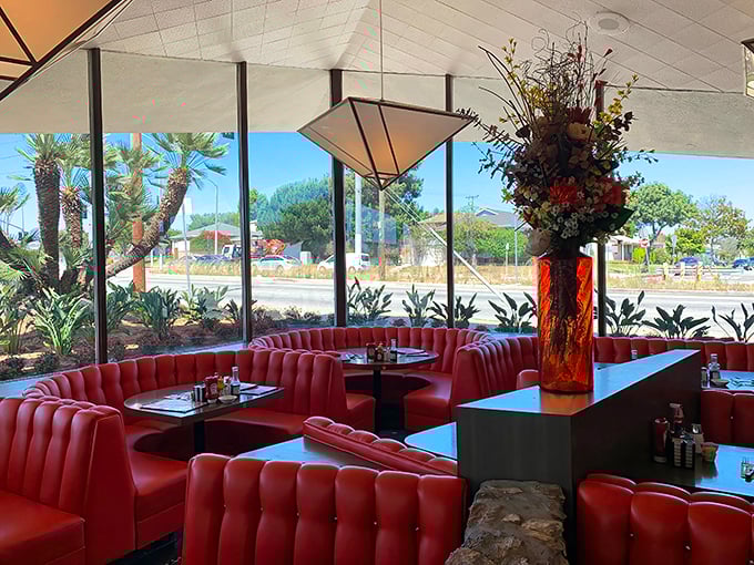 Curved booths that cradle conversations and California sunshine streaming through floor-to-ceiling windows. This corner spot is prime real estate.