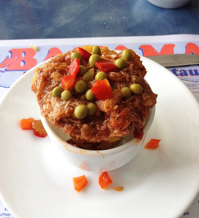 Tostones rellenos crowned with savory crab – the Caribbean's answer to the loaded potato. Two culinary traditions collide in delicious harmony.