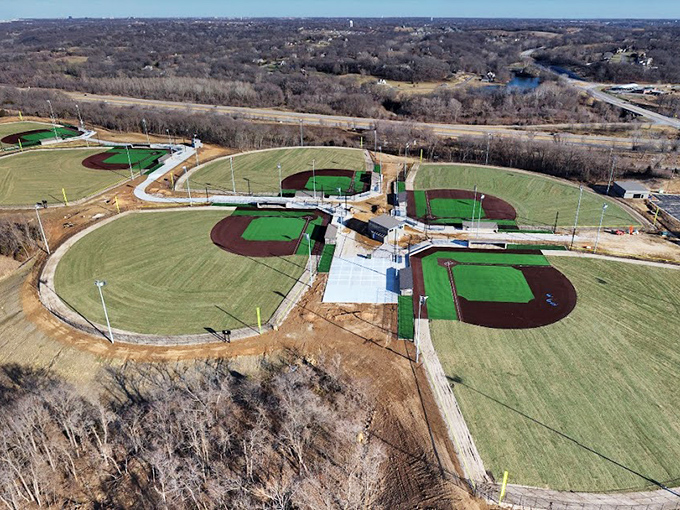Baseball diamonds arranged like a perfect necklace—where future major leaguers and weekend warriors share the same Missouri clay.