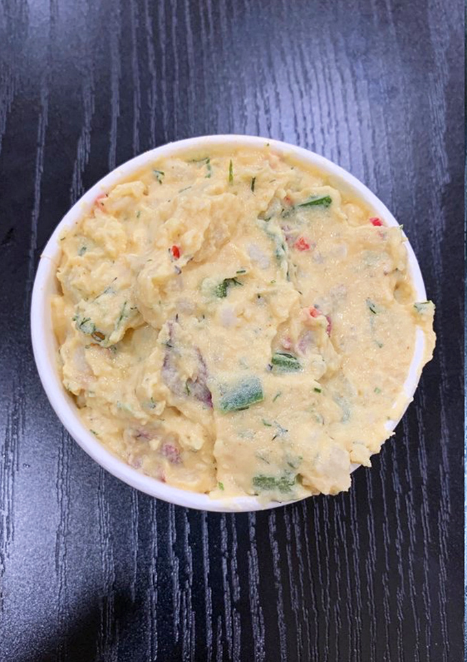 Potato salad with personality—the cooling counterbalance that prevents your taste buds from sending distress signals to your brain.