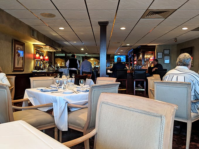 The dining room hums with the satisfied murmurs of patrons experiencing food that lives up to the elegant setting. White tablecloths never lie.