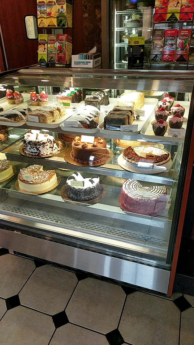 Tempting dessert display case filled with homemade cakes and treats for the perfect meal finale.