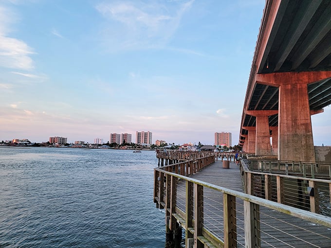 The fishing pier stretches toward possibility, where sunset strollers and anglers share the unspoken agreement that this view needs no filter.