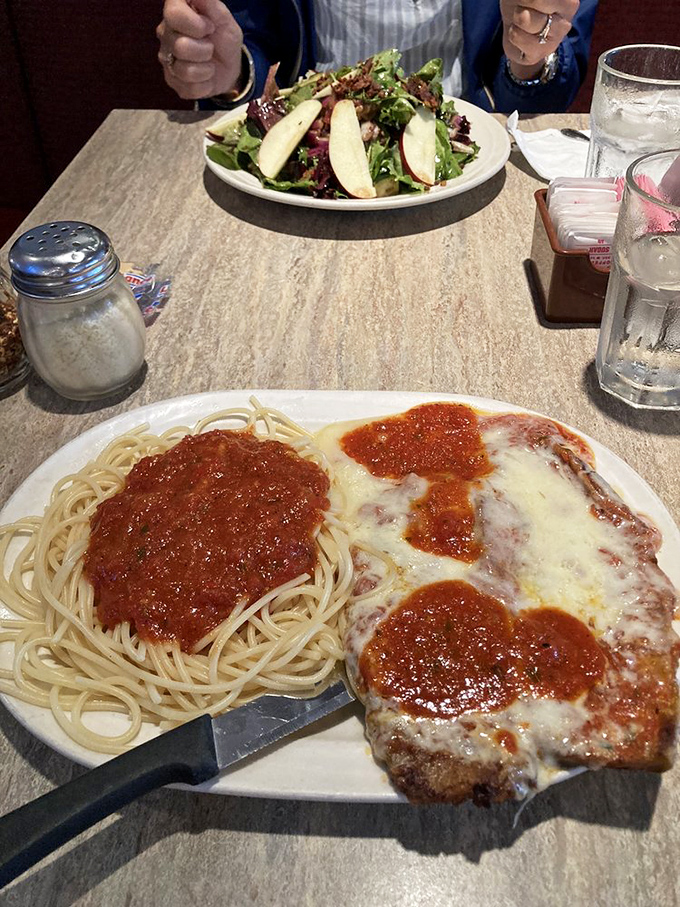 A plate of Italian-American comfort that would make Tony Soprano misty-eyed. That melted cheese blanket is tucking in some serious flavor underneath. 