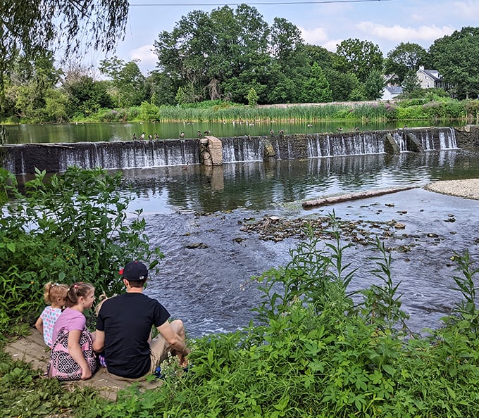 Family bonding by the waterfall—no screens, no distractions, just the timeless entertainment of watching water do what it's done for millennia.