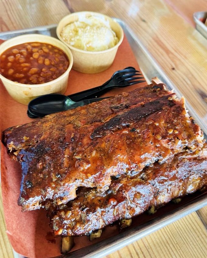 These ribs aren't just food—they're architecture. A glistening monument to patience, smoke, and the pursuit of perfection, with beans and potato salad as worthy companions.