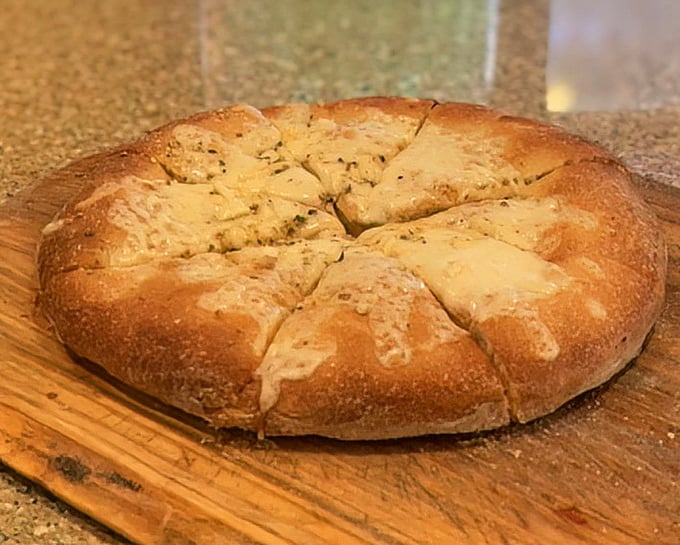 Garlic bread that's been working out – robust, golden, and ready to be torn apart. The perfect opening act to any pizza performance.