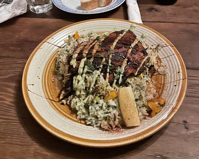 This isn't just fish over rice—it's a perfectly cooked piece of halibut, seasoned and seared by someone who respects both the ingredient and the person about to enjoy it.