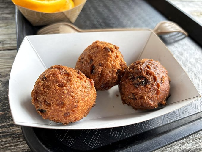 Hush puppies that would make your Southern grandmother nod in approval. Crispy outside, tender inside—the perfect seafood sidekick.