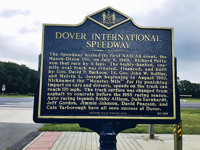 This historical marker tells the tale of Dover International Speedway, though it curiously omits any mention of concrete monsters.