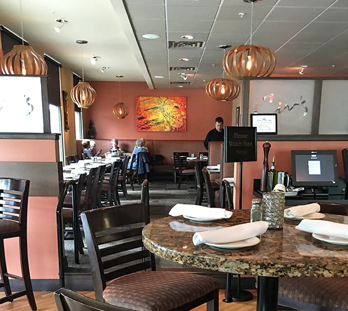 Modern pendant lighting illuminates a space where traditional Italian hospitality meets contemporary comfort and style perfectly.