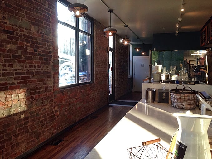 Exposed brick walls and natural light create an atmosphere that says, "Yes, this place takes chicken seriously, but not itself."
