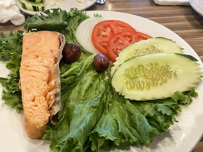 A salmon fillet lounging on a bed of crisp lettuce with cucumber, tomato and olives – the Mediterranean vacation your taste buds have been craving.