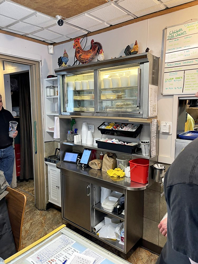 Behind the scenes, where chicken magic happens – note the rooster decorations watching over their delicious descendants.