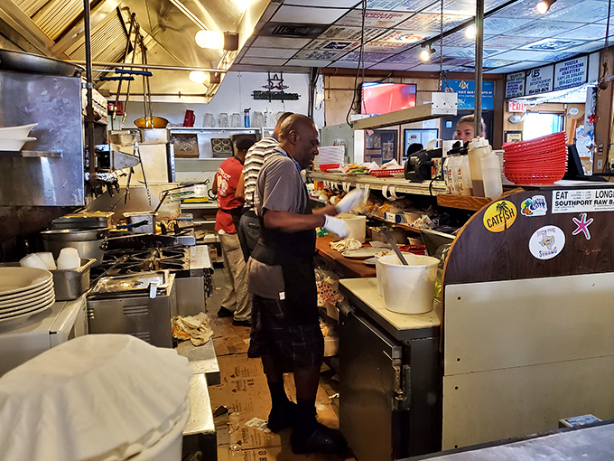 Where the magic happens—a kitchen that prioritizes flavor over fanciness. These hands have prepared more seafood than most people will eat in a lifetime.